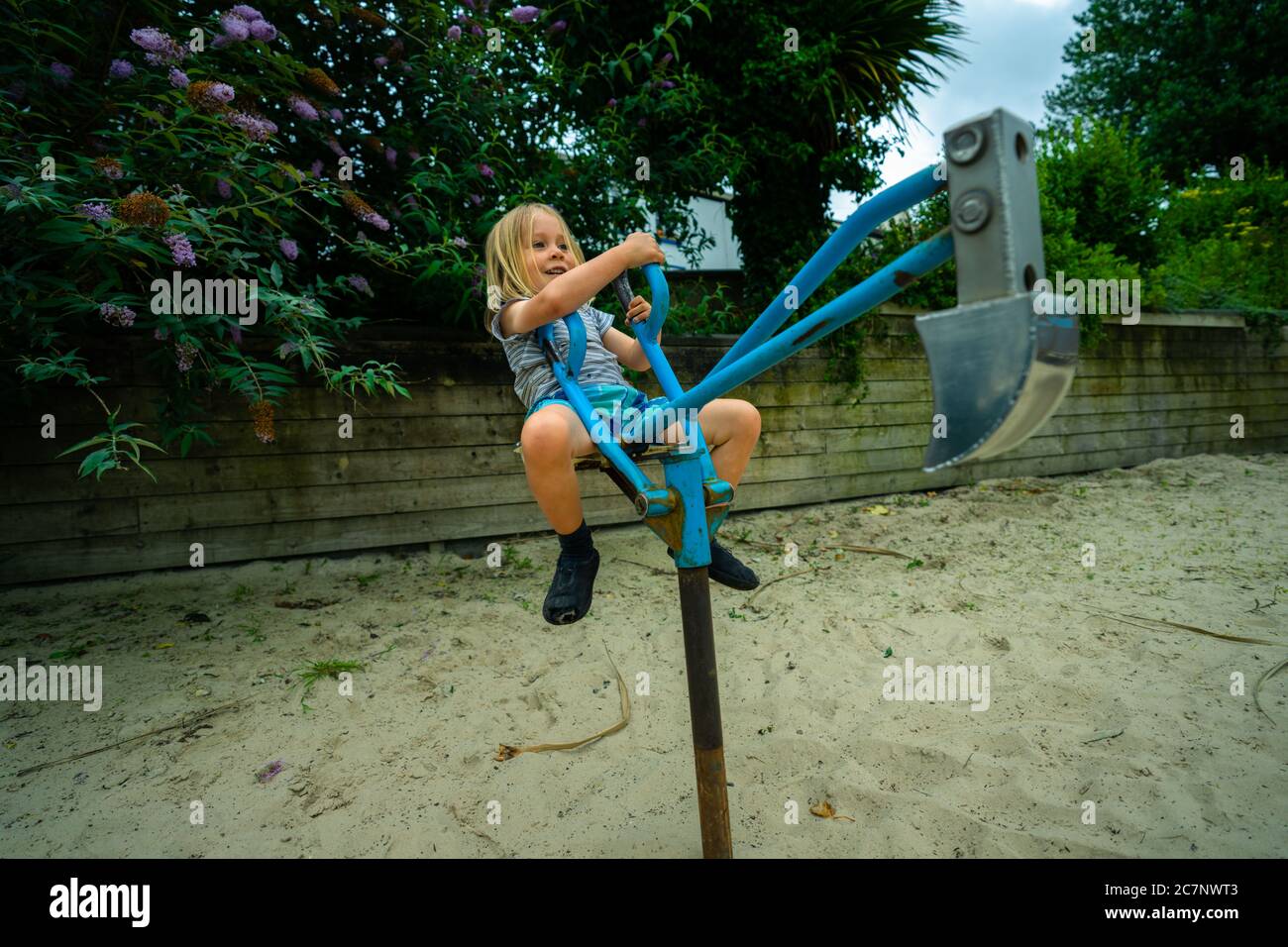 A little preschooler playing with a digger in a sandpit Stock Photo - Alamy
