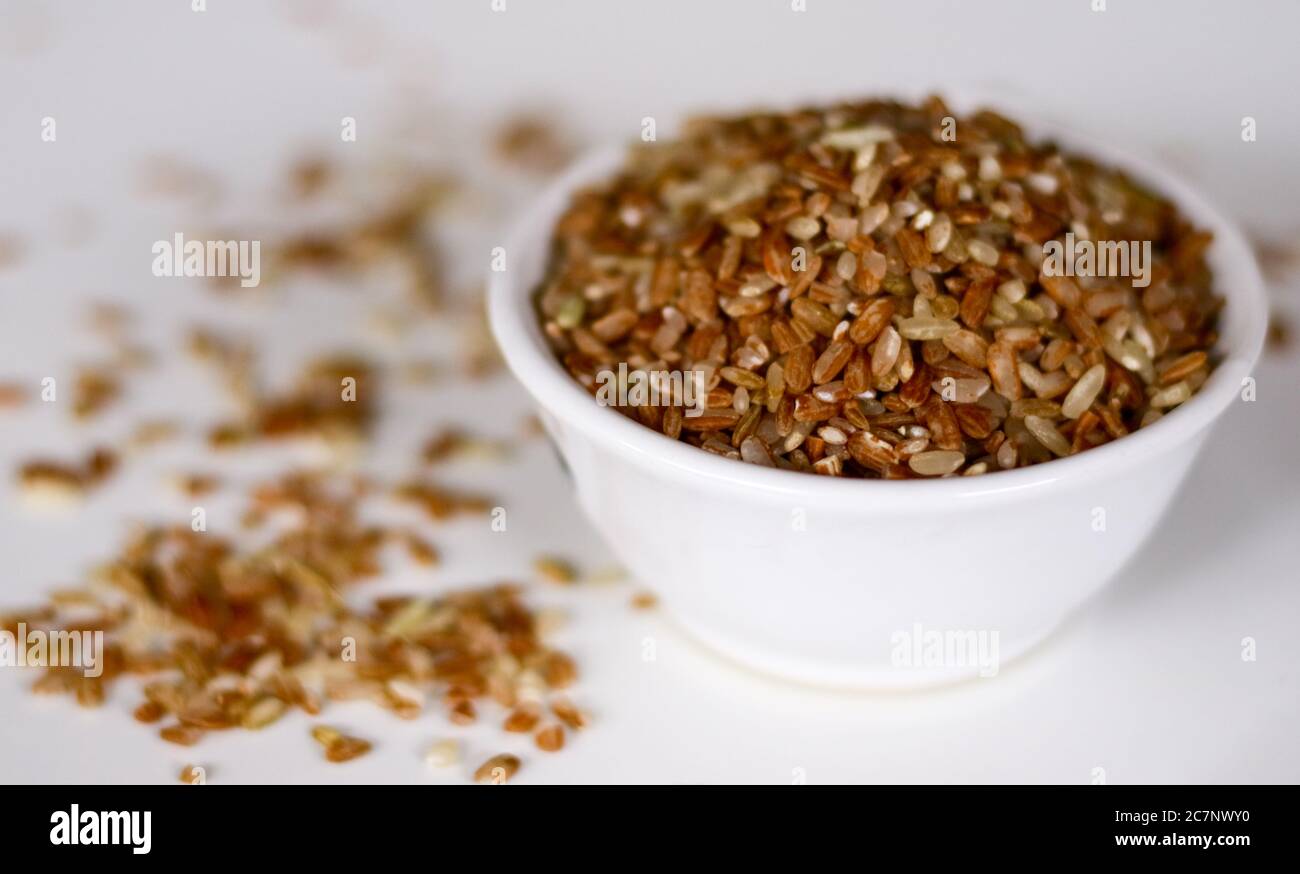 Brown rice on white background Stock Photo - Alamy