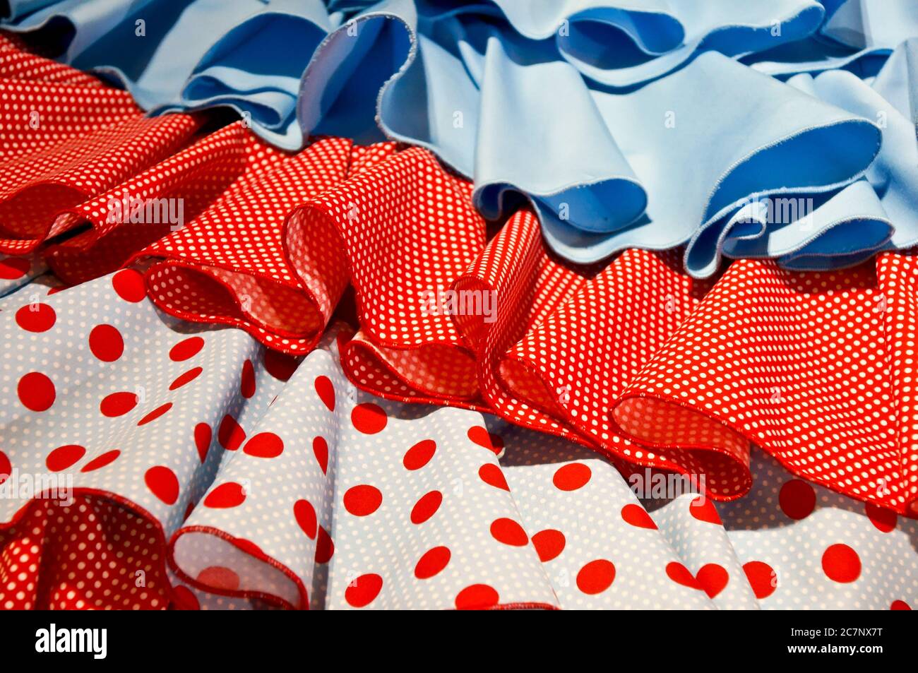 Closeup shot of three different multicolored Spanish flamenco dress ...
