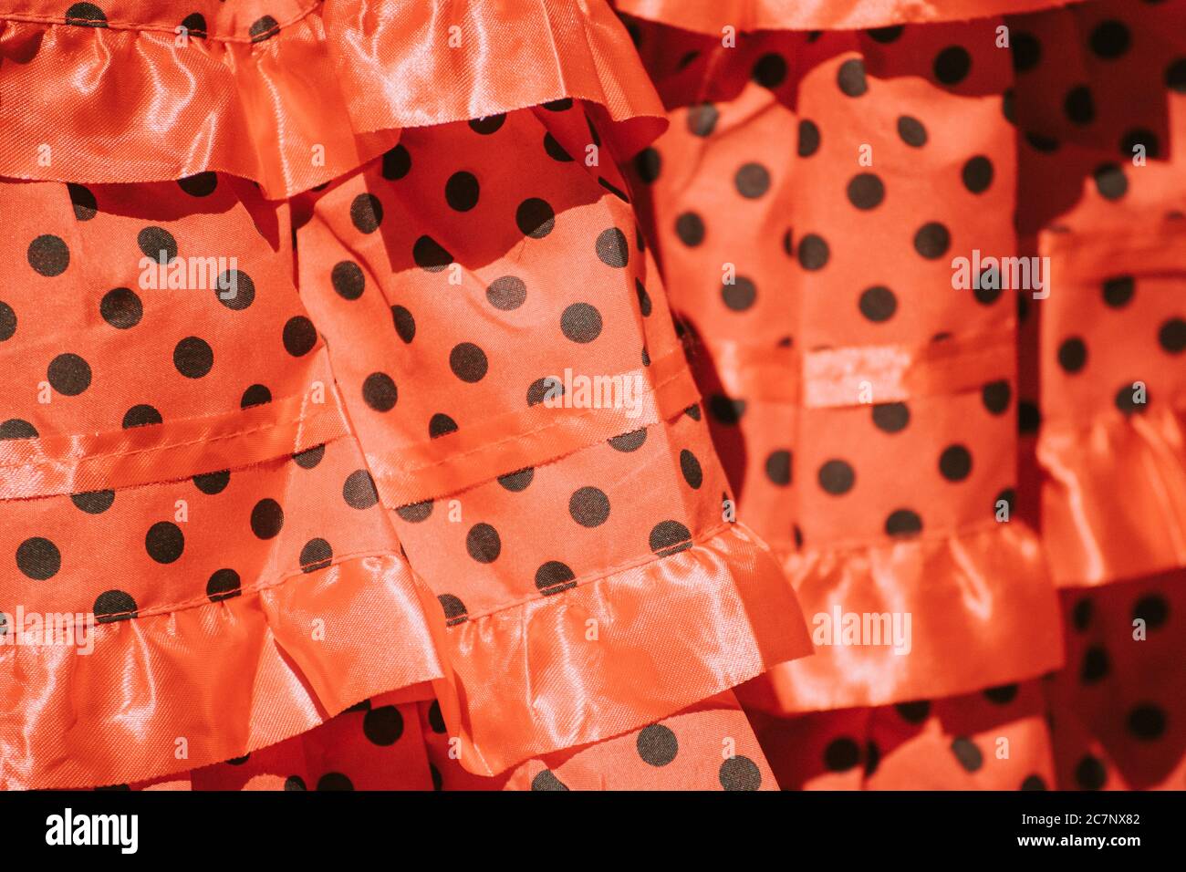 Closeup of Spanish flamenco dress red fabric with black polka dots and ...