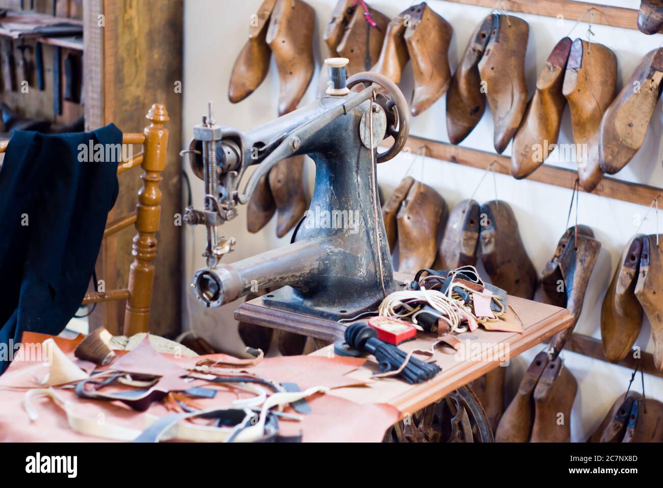 Busy workspace in a traditional old shoe shop Stock Photo - Alamy
