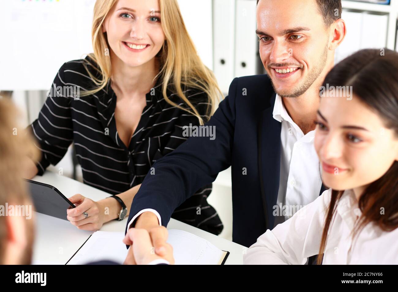 Smiling man in suit shake hands as hello Stock Photo - Alamy
