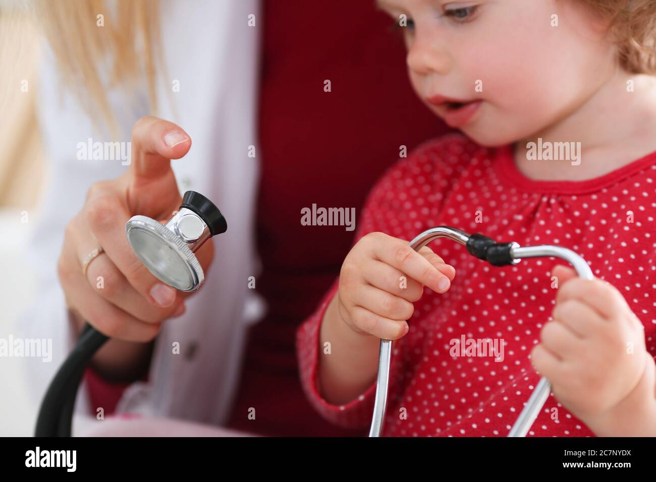 Little child with stethoscope at doctor reception Stock Photo - Alamy