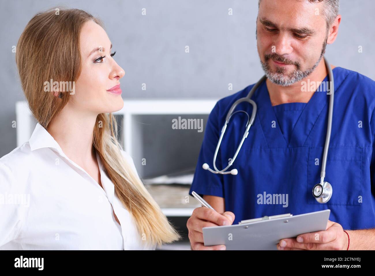 Smiling handsome doctor communicate with patient Stock Photo - Alamy