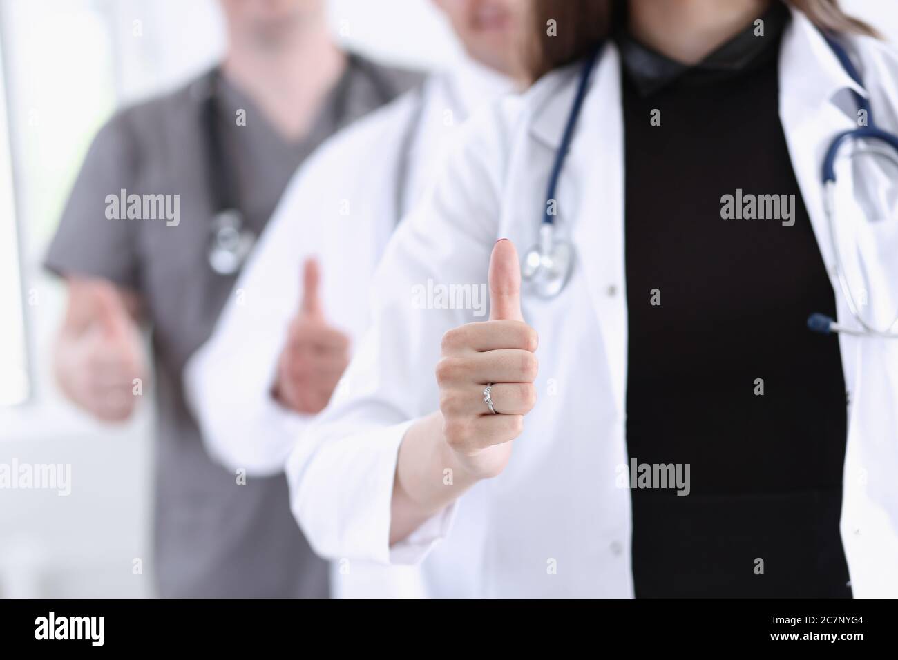 Group of doctor show OK or approval sign with thumb up Stock Photo - Alamy