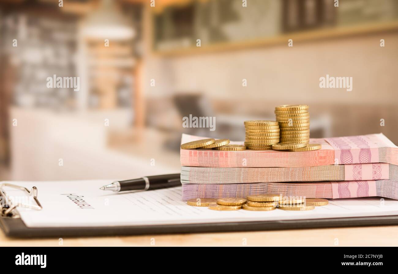 money put on loan application form with cafe in background. concept of ...