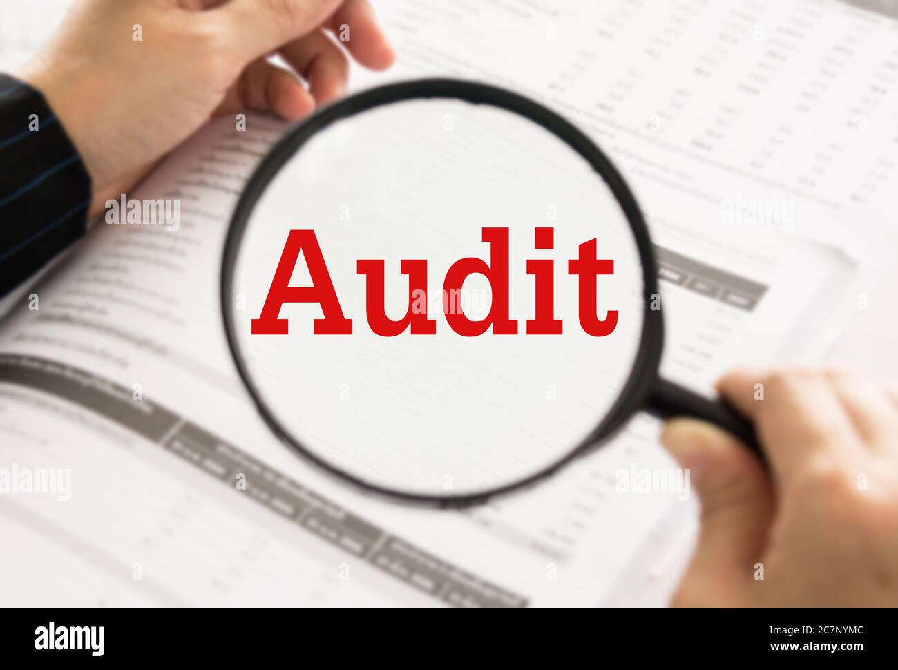 Audit concept. Auditor or IRS using magnifier auditing revenue in ...