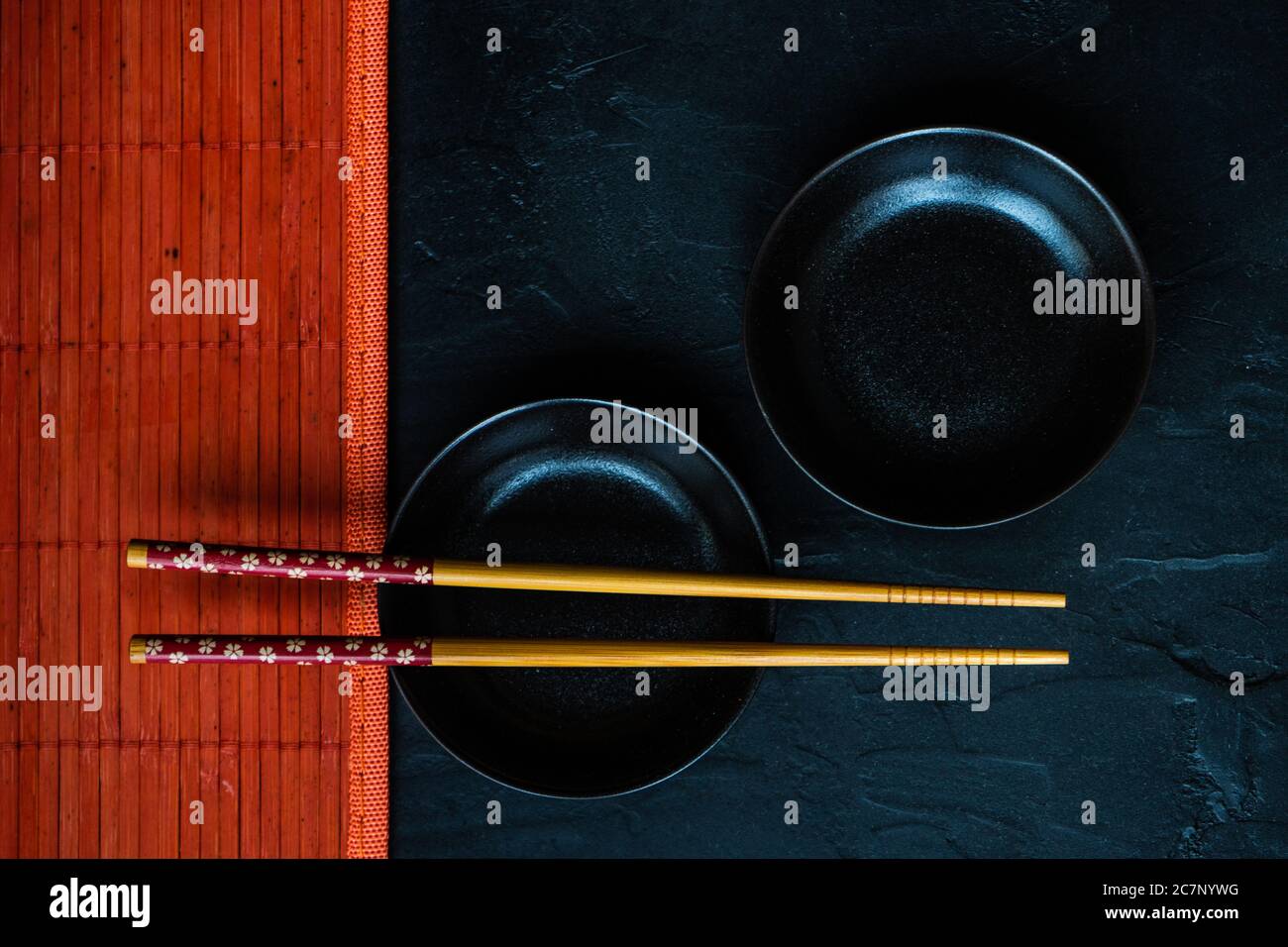 Asian table setting with chopsticks on stone background with copy space ...