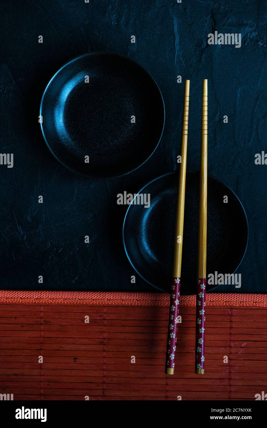Asian table setting with chopsticks on stone background with copy space ...