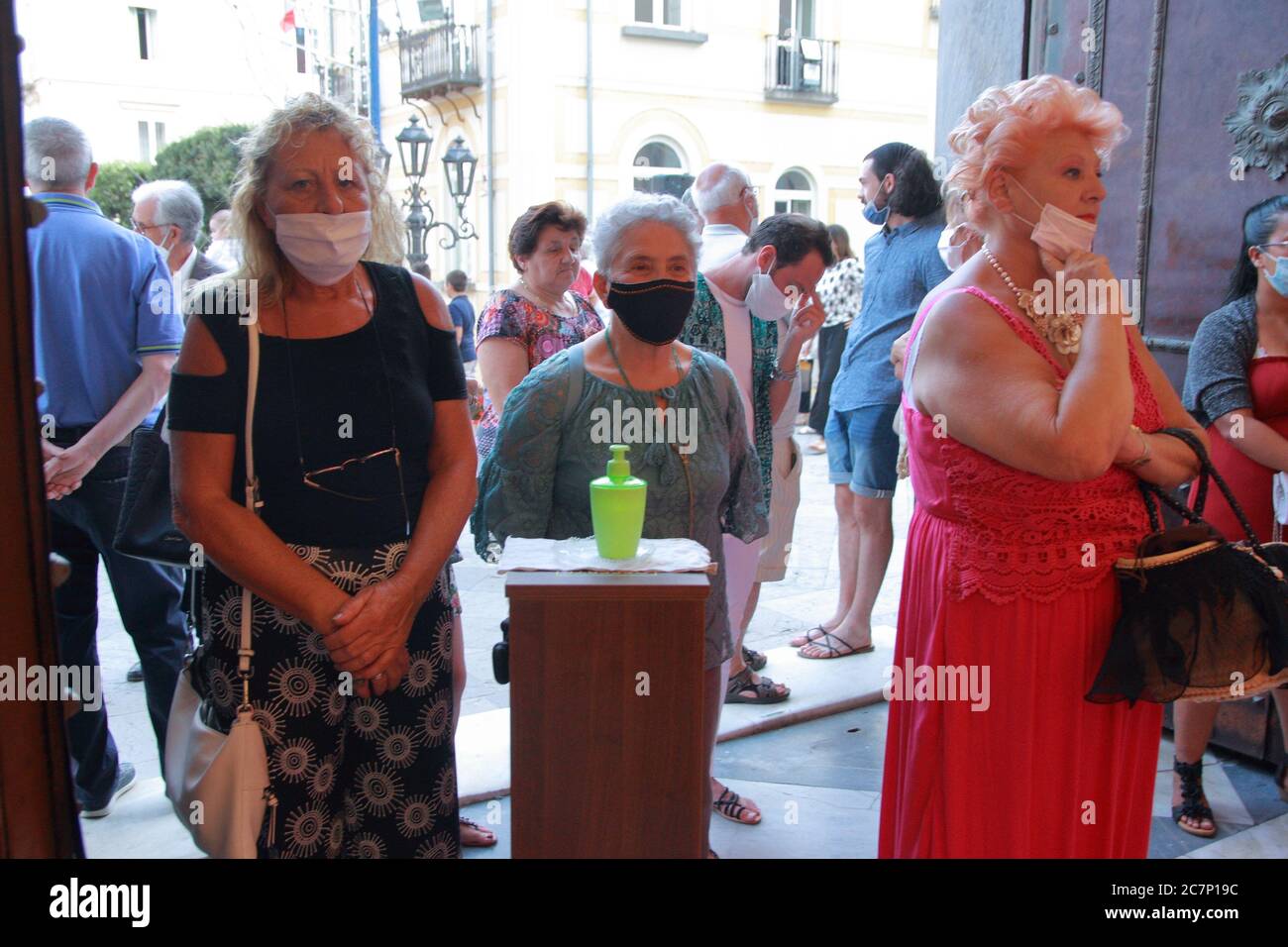 The faithful before entering the church put on their hands a sanitizing ...