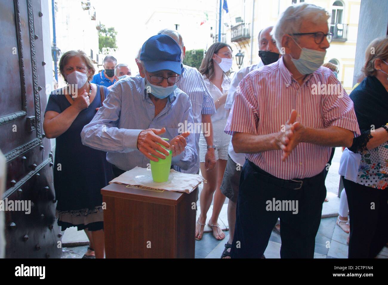 The faithful before entering the church put on their hands a sanitizing ...