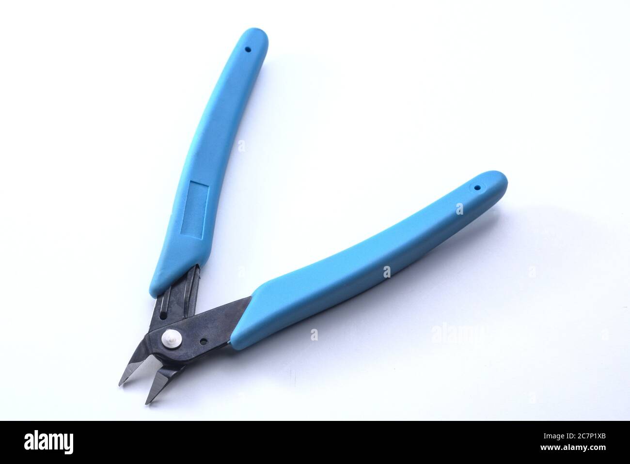 A horizontal shot of a light blue plier on a white background Stock ...