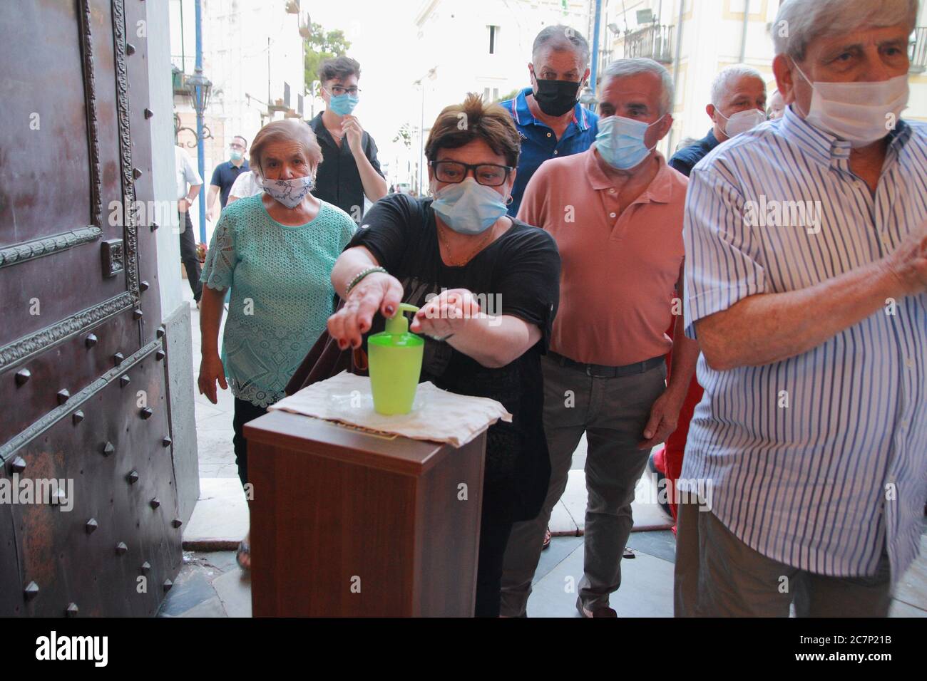 The faithful before entering the church put on their hands a sanitizing ...