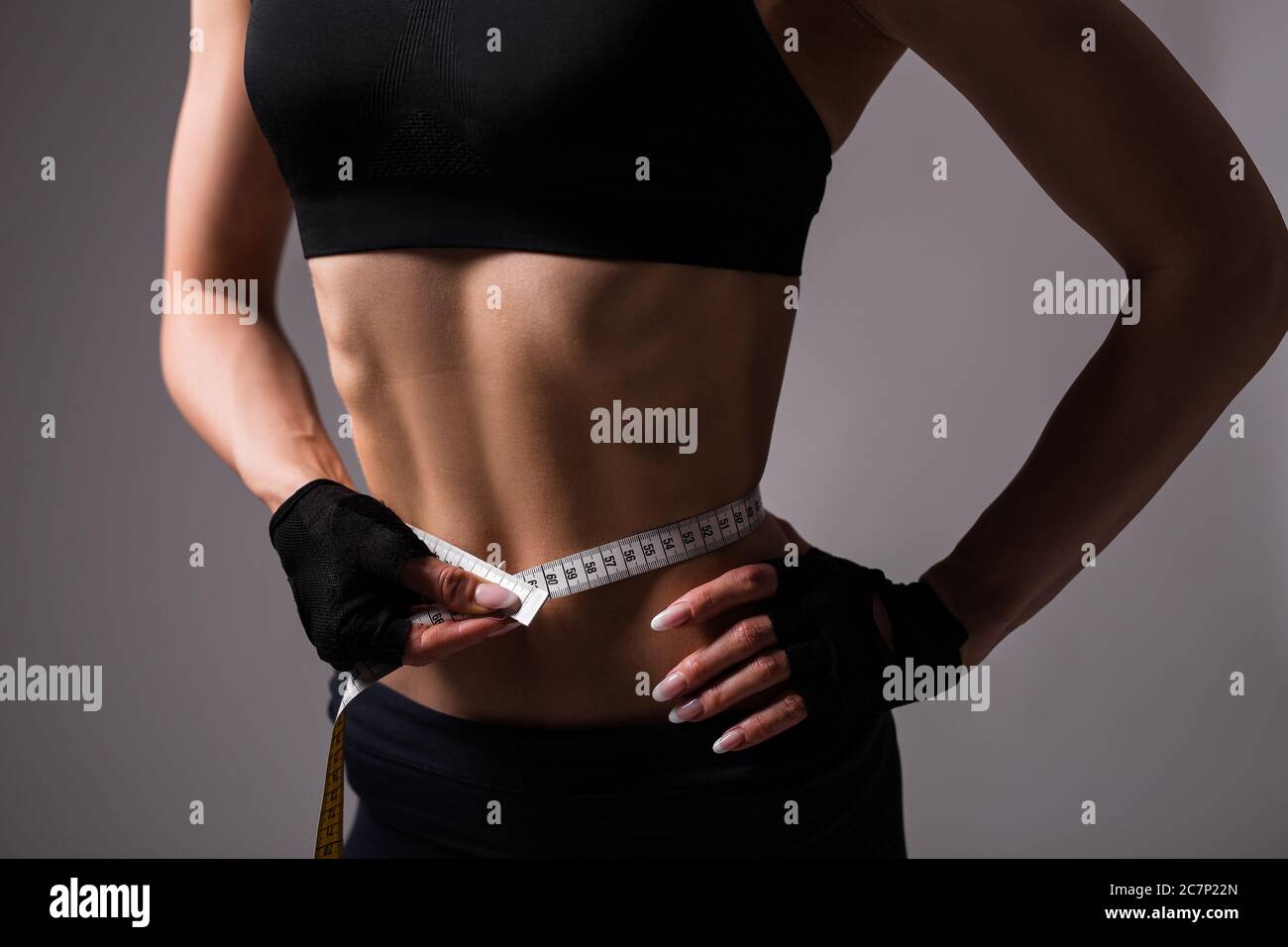 Muscular female measuring her waist hi-res stock photography and images ...