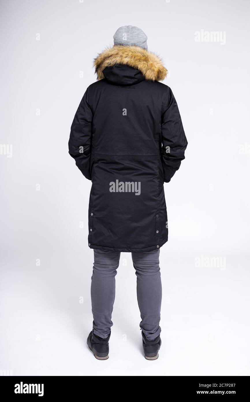 back view of man posing in black warm winter jacket over gray ...