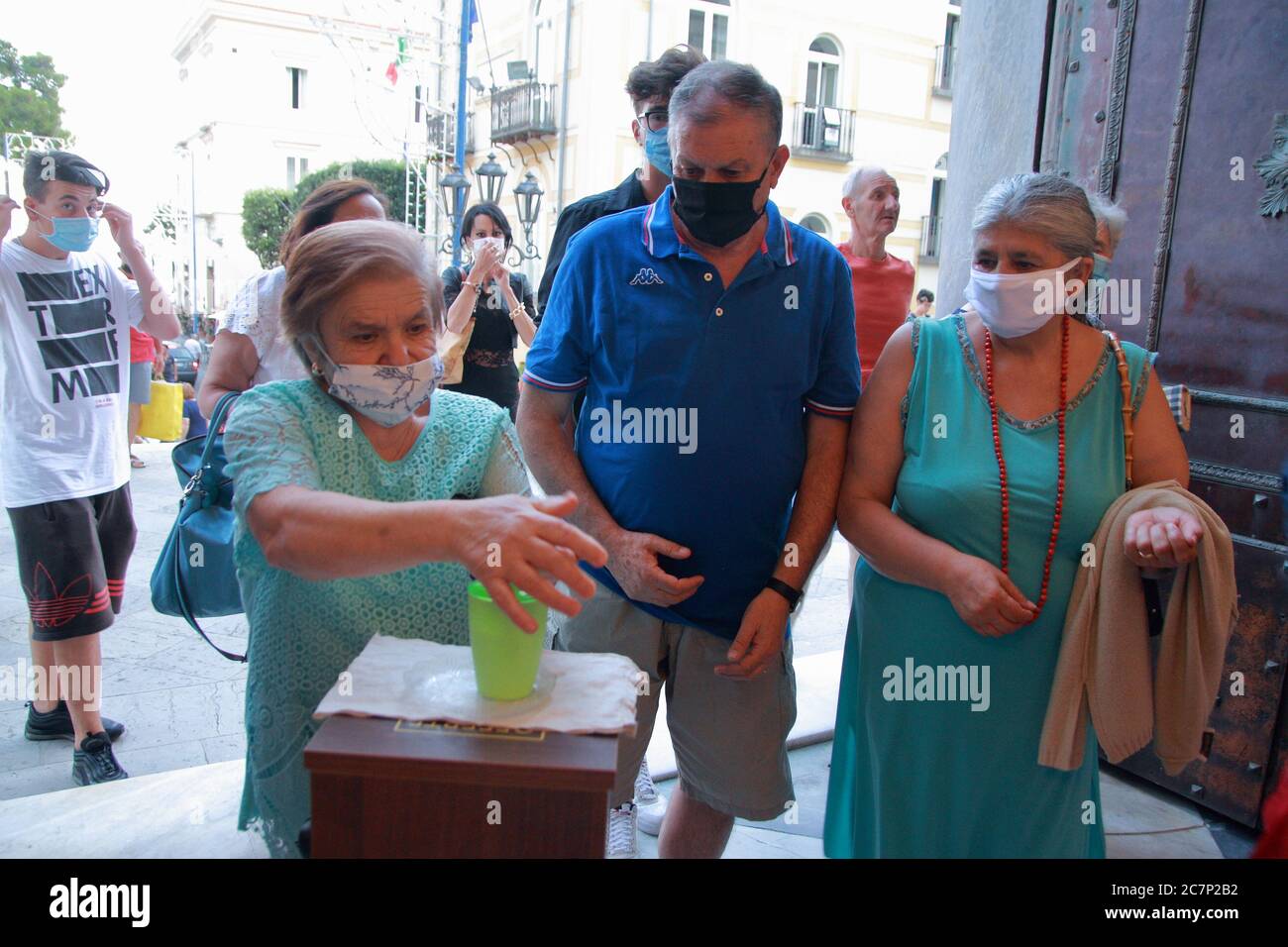 The faithful before entering the church put on their hands a sanitizing ...