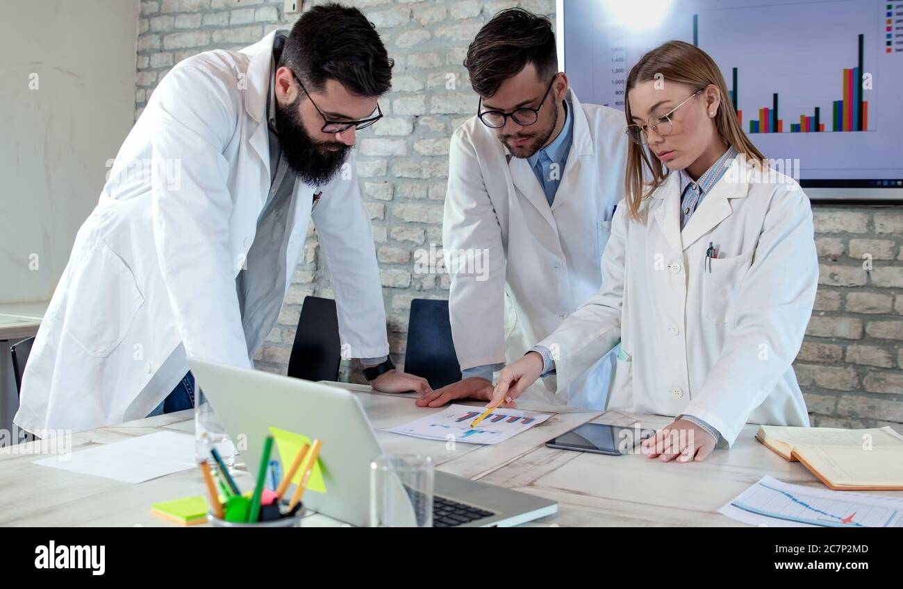 Group of doctors discussing possible solutions for resolving Covid-19 ...