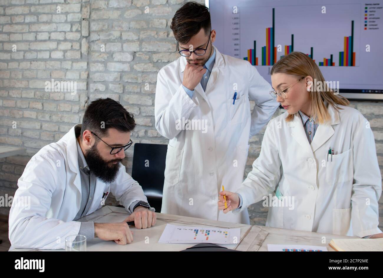 Group of doctors discussing possible solutions for resolving Covid-19 ...