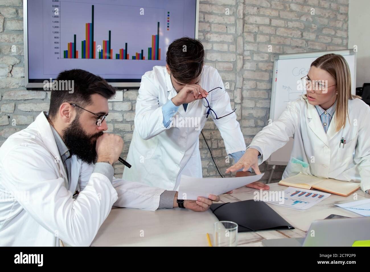 Group of doctors discussing possible solutions for resolving Covid-19 ...