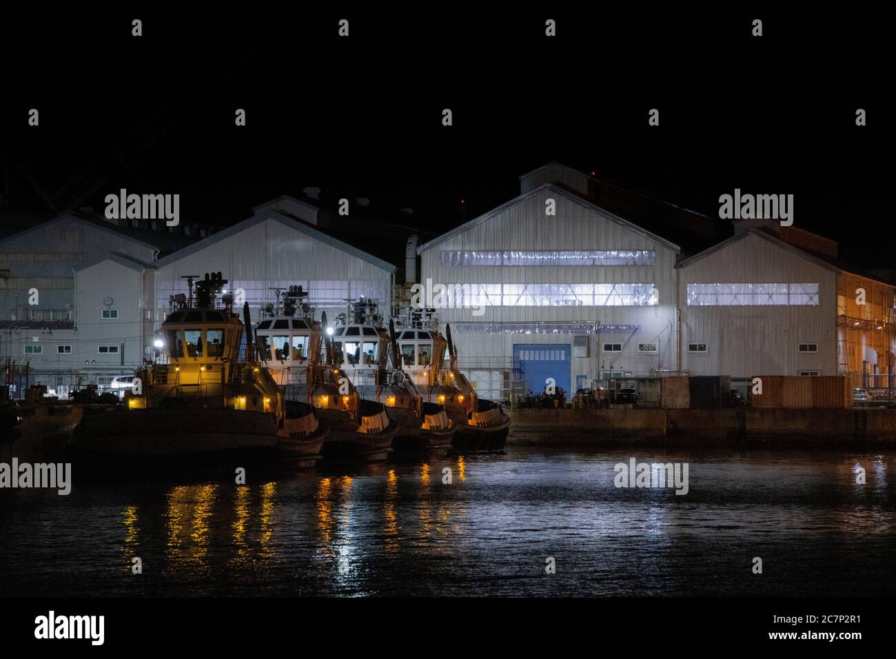 Tugs waiting in the dock yards of Tokyo for the arrival of large ships ...
