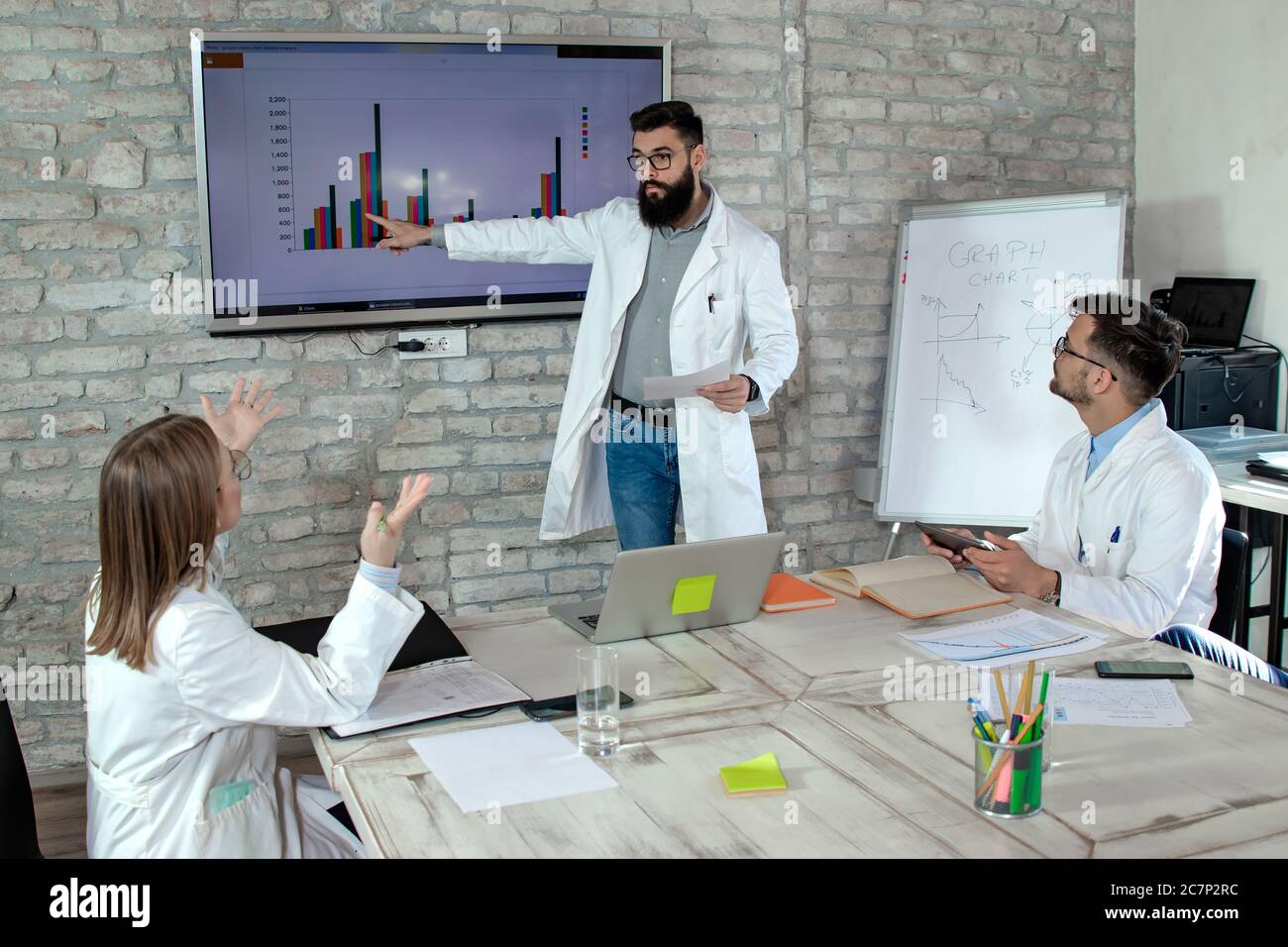 Group of doctors discussing possible solutions for resolving Covid-19 ...