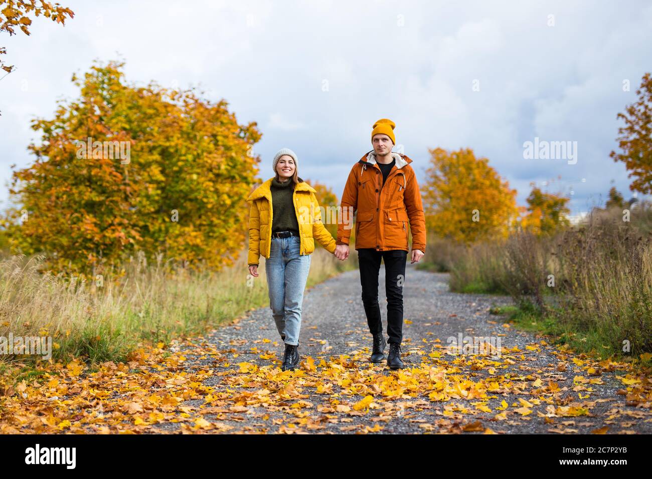 happy young beautiful couple walking in autumn park Stock Photo - Alamy