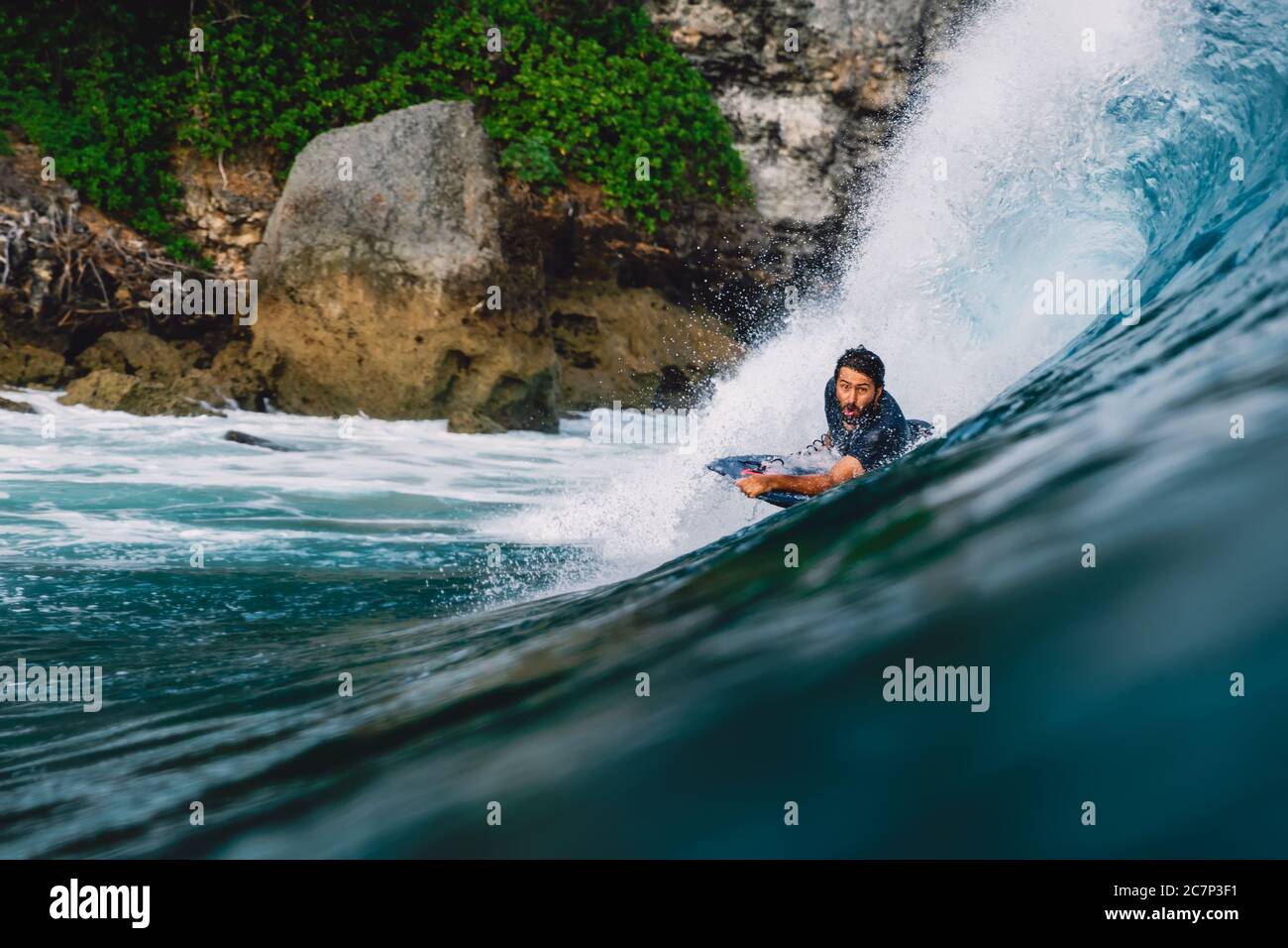 July 12, 2020. Bali, Indonesia. Surfer ride on bodyboard at wave ...