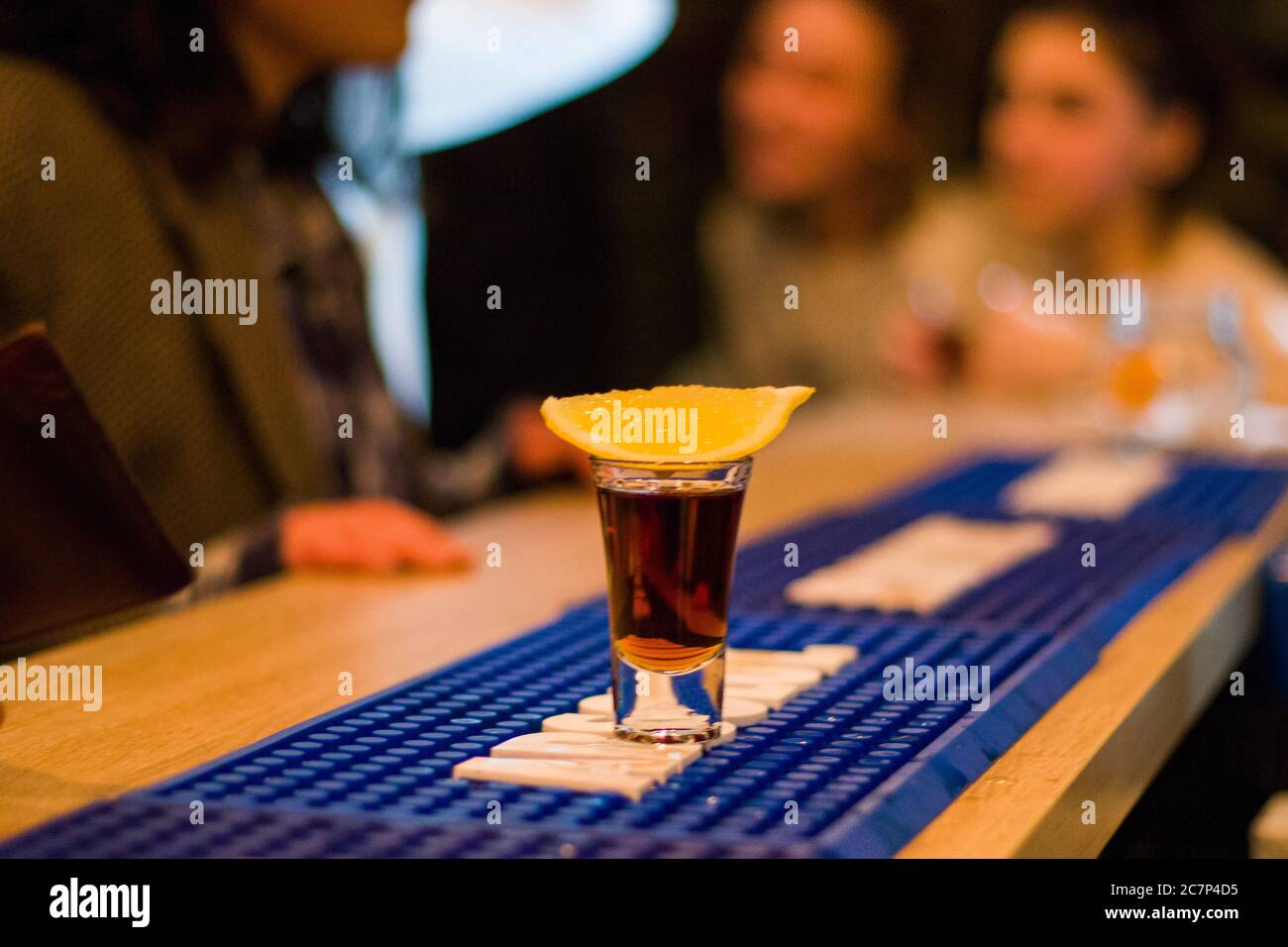 shot in on the bar table with lemon, alcoholic drink in glass, alcohol ...