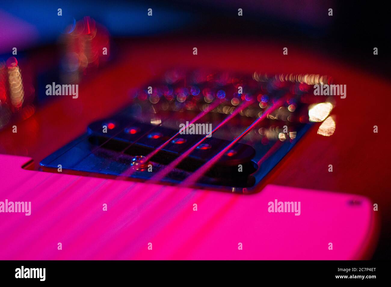 Musical instrument guitar body close-up an macro background, red color ...