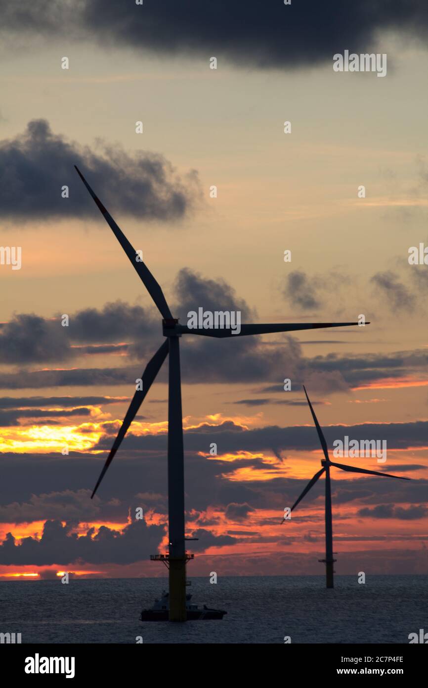 Amazing shot of wind turbines on a sunset background Stock Photo - Alamy
