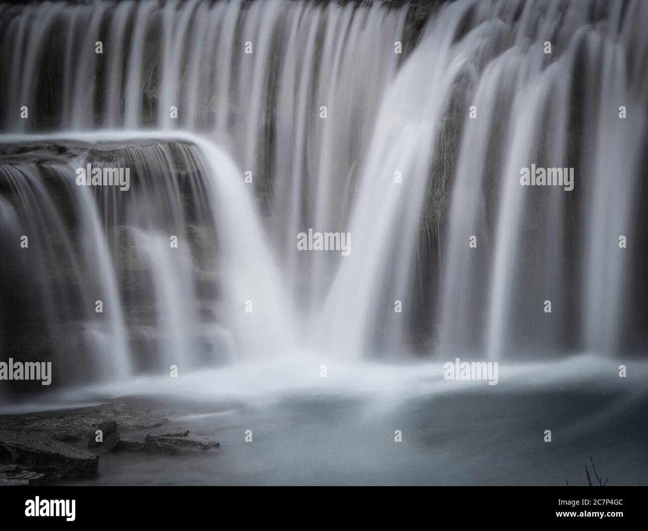 Breathtaking view of the waterfall falling over the calm and beautiful ...
