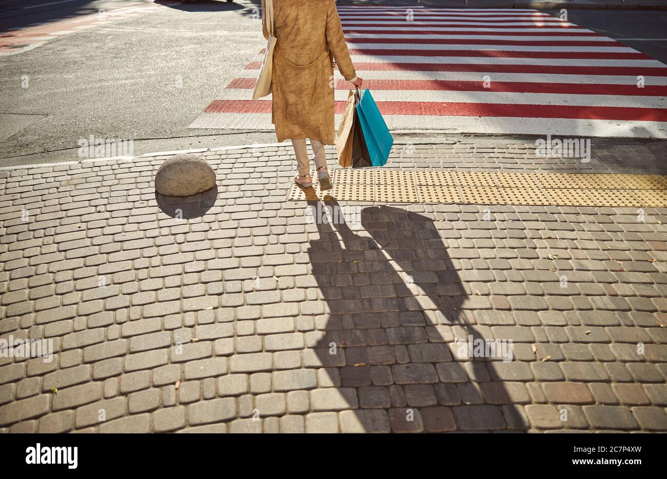 Female walking through the street with shopping bags in hand Stock ...