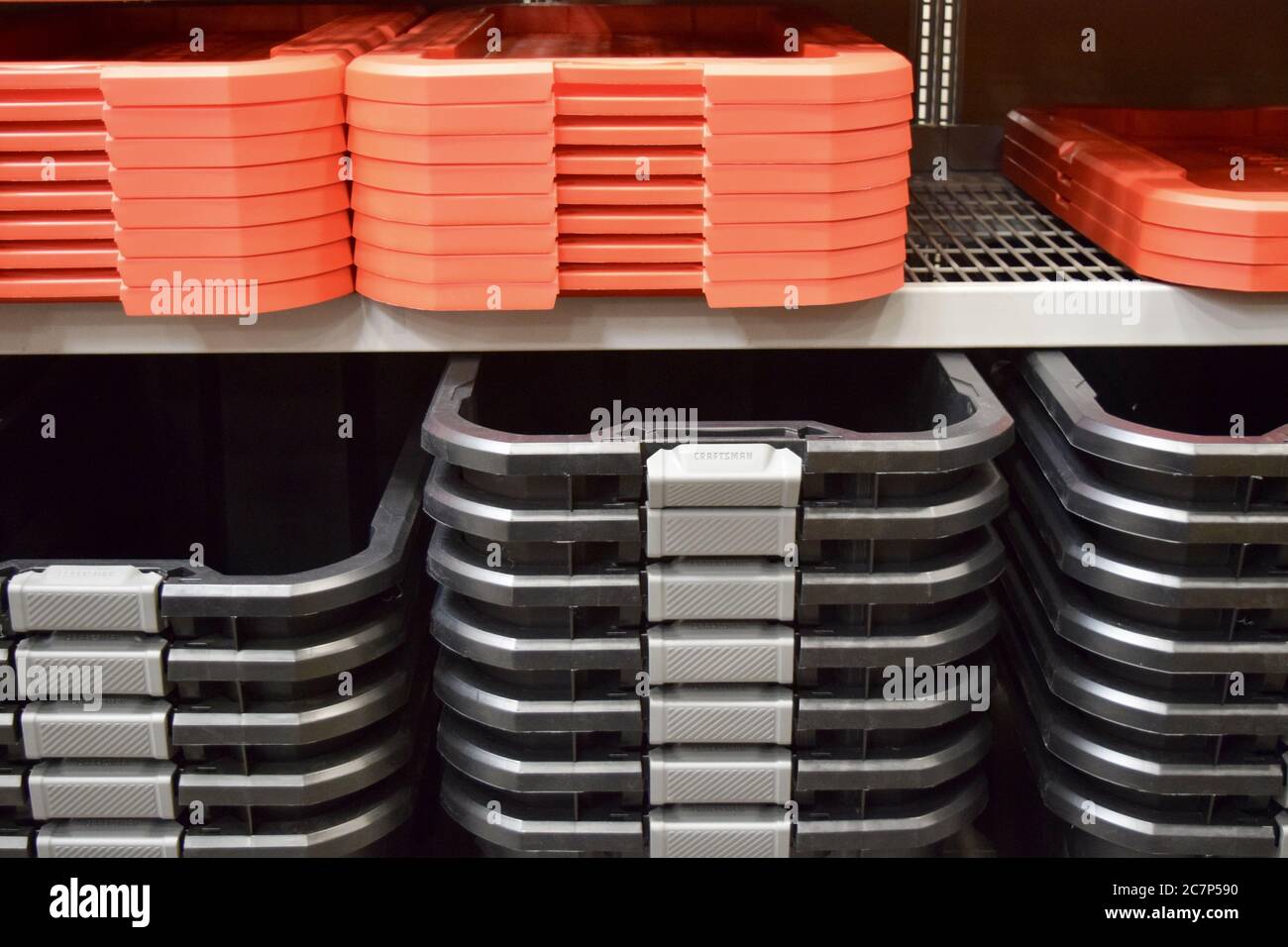 Closeup shot of black plastic containers and red stacked lids on ...