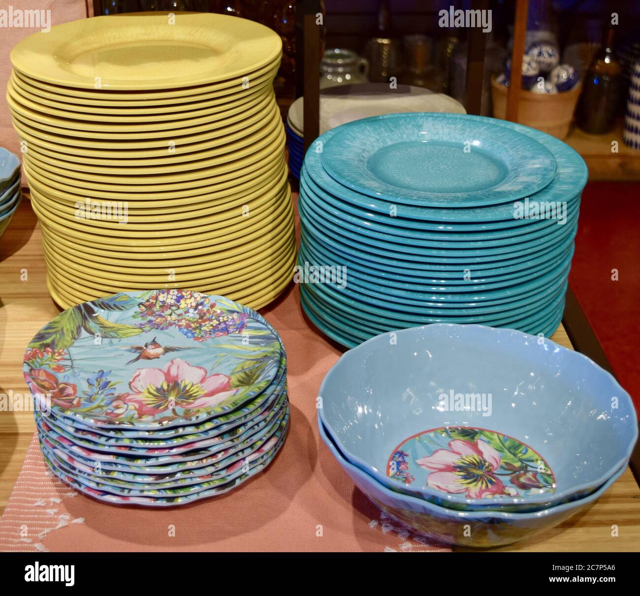 Front view of stacks of colorful decorative modern plates at a store ...