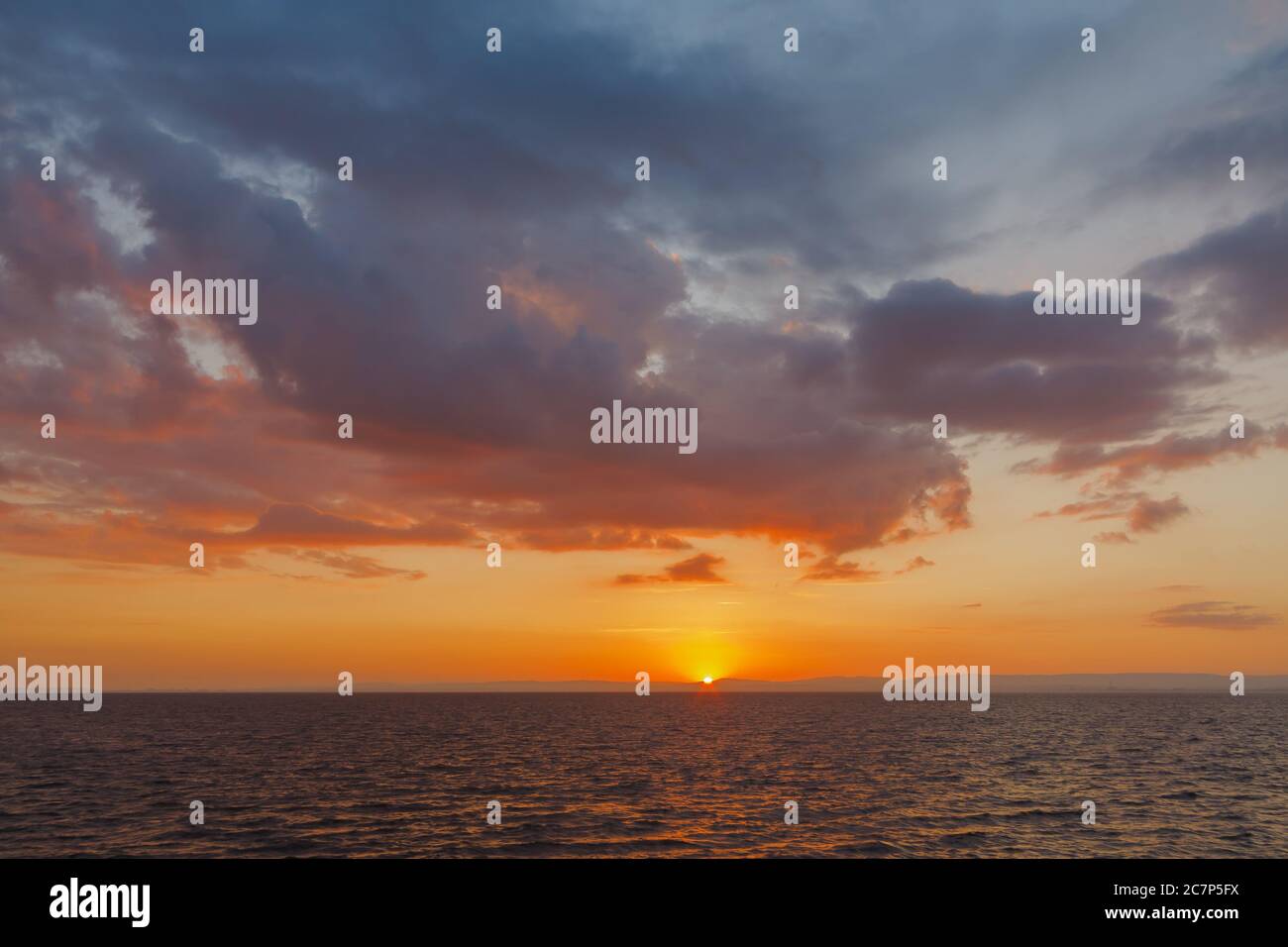 The sun about to set over the horizon Stock Photo - Alamy