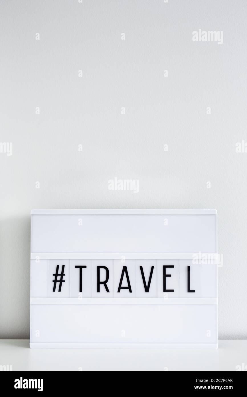 retro light box with travel hash tag and copy space over white wall ...
