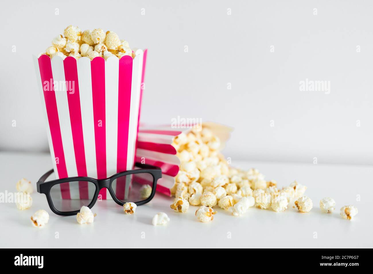 close up of striped boxes with popcorn, 3d glasses and copy space over white background Stock ...