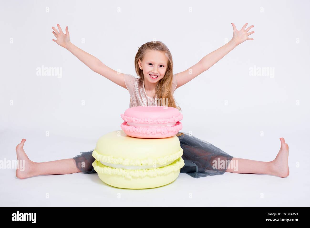 cute little girl with big macaroons over white background Stock Photo ...