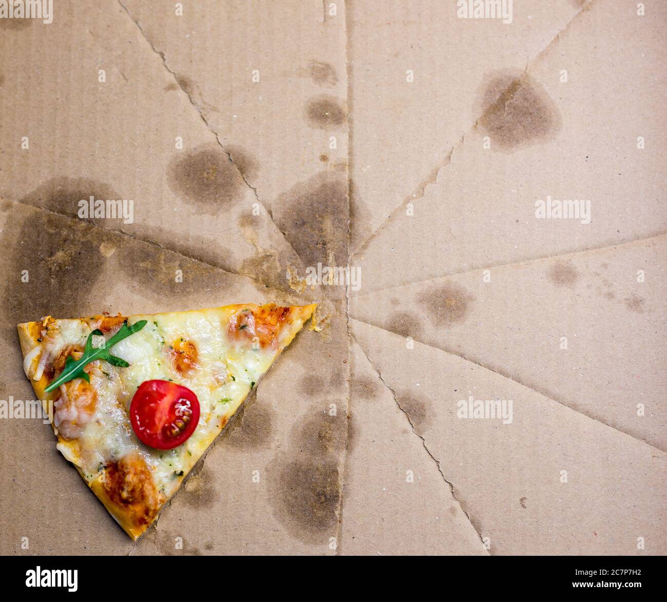 close up of last pizza slice in cardboard delivery box Stock Photo - Alamy