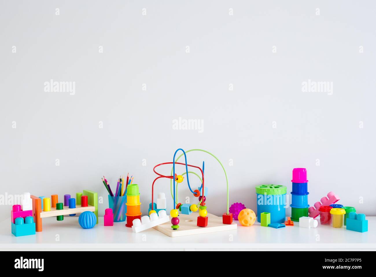 colorful toys and copy space over white wall background Stock Photo - Alamy
