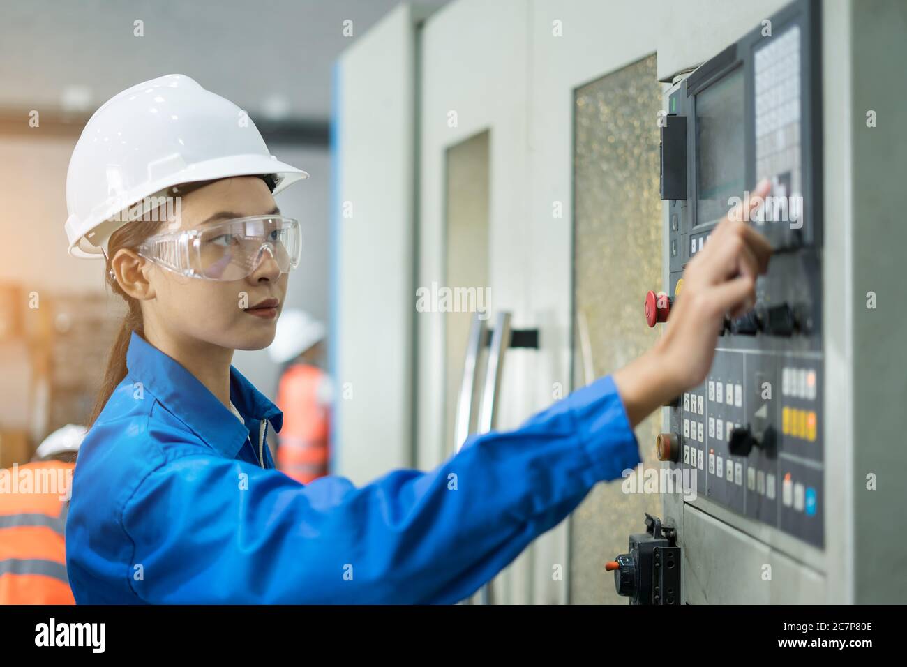 Female factory worker check a machine. Women technician engineering ...