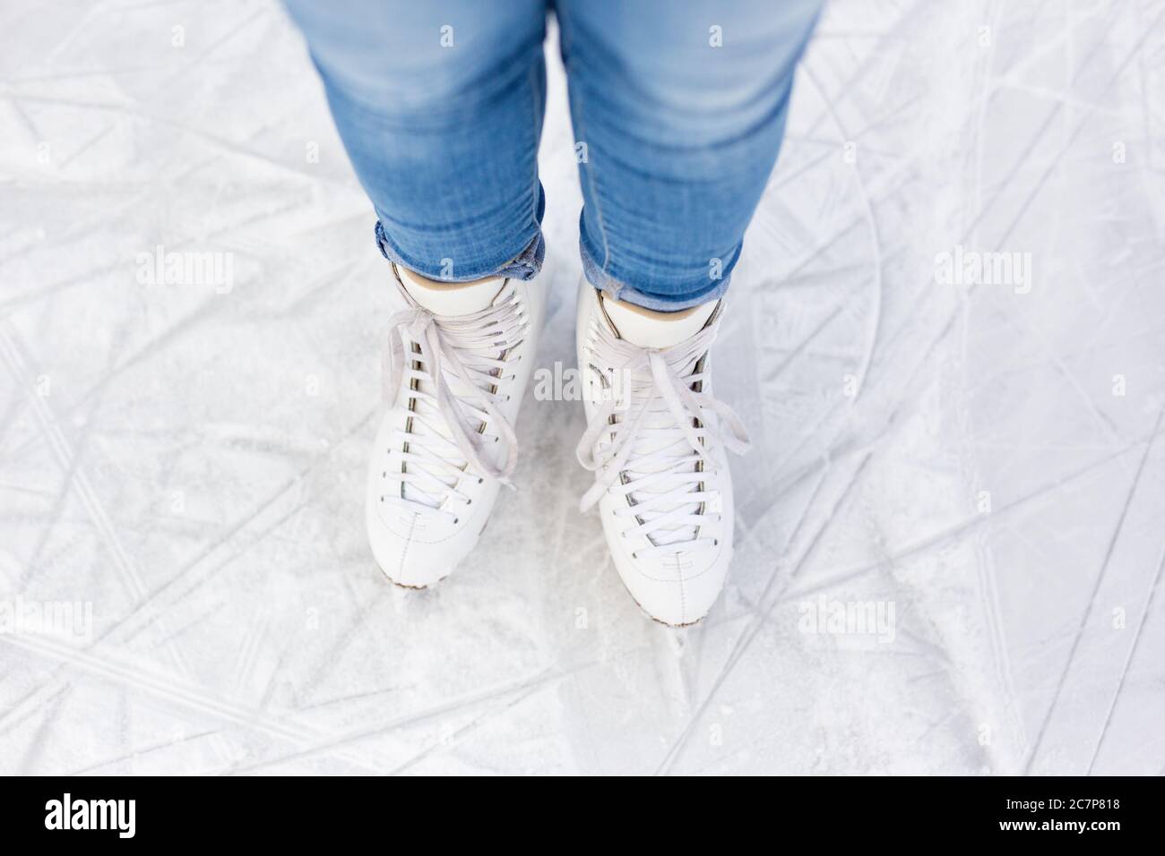 top view of legs in new skates over white ice at rink Stock Photo - Alamy