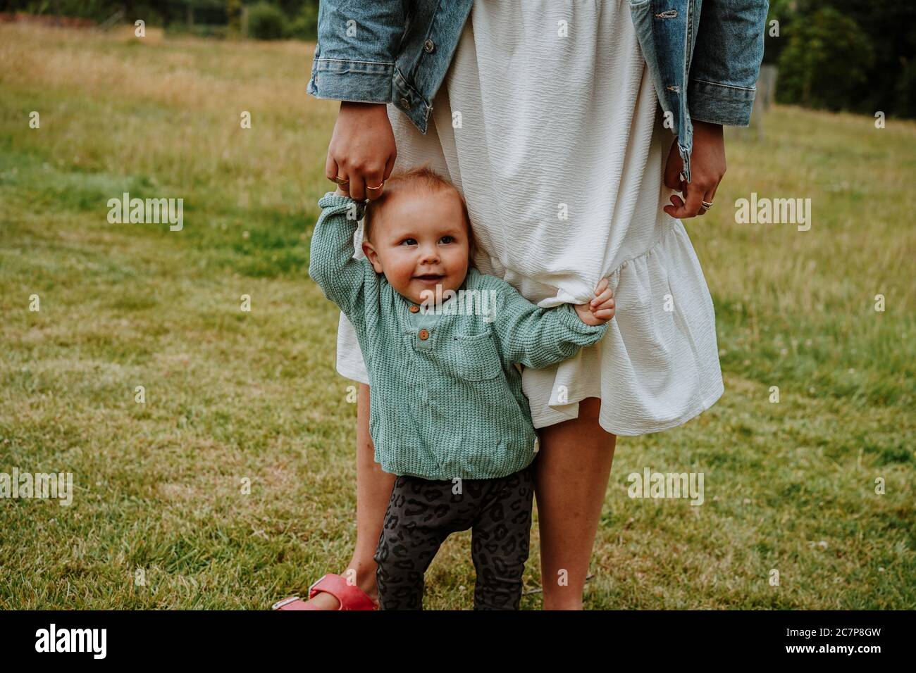 Young toddler holding mum's hand Stock Photo - Alamy