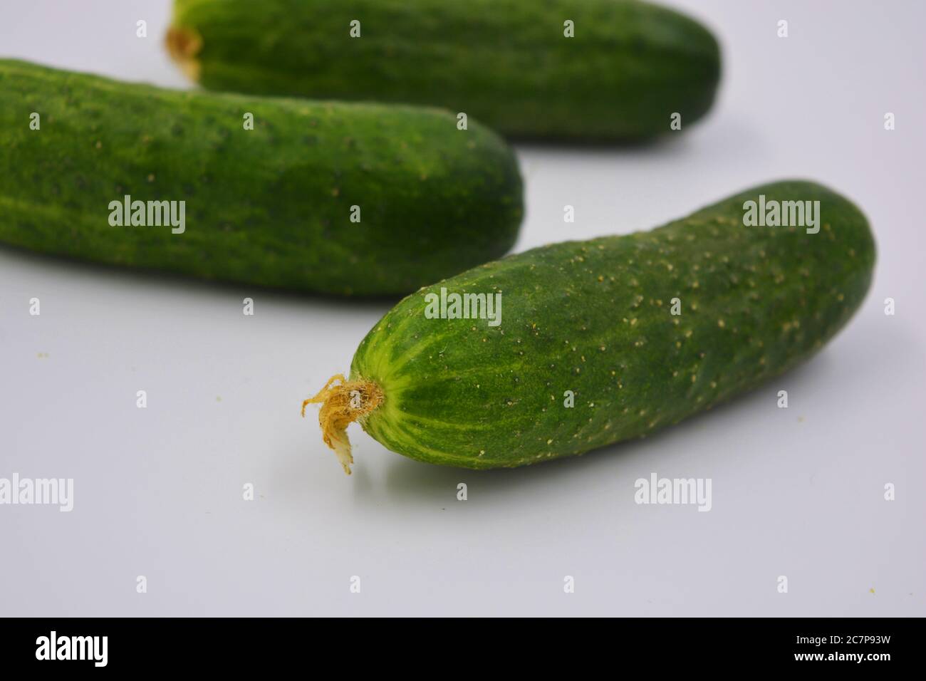 Three young juicy cucumbers, Ukrainian cucumber harvest arranged on a ...