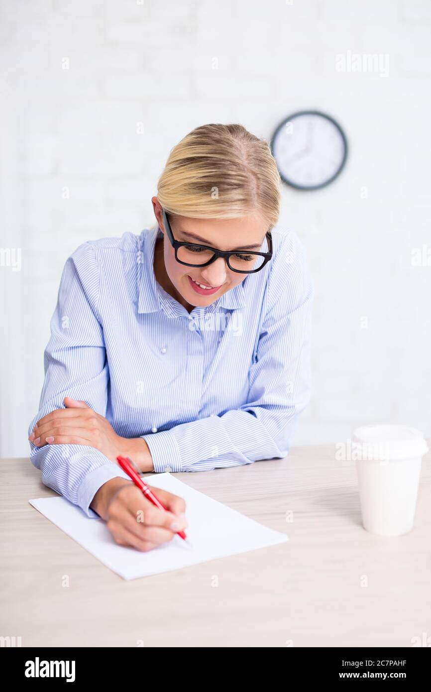 creativity and education concept - beautiful girl writing something in ...