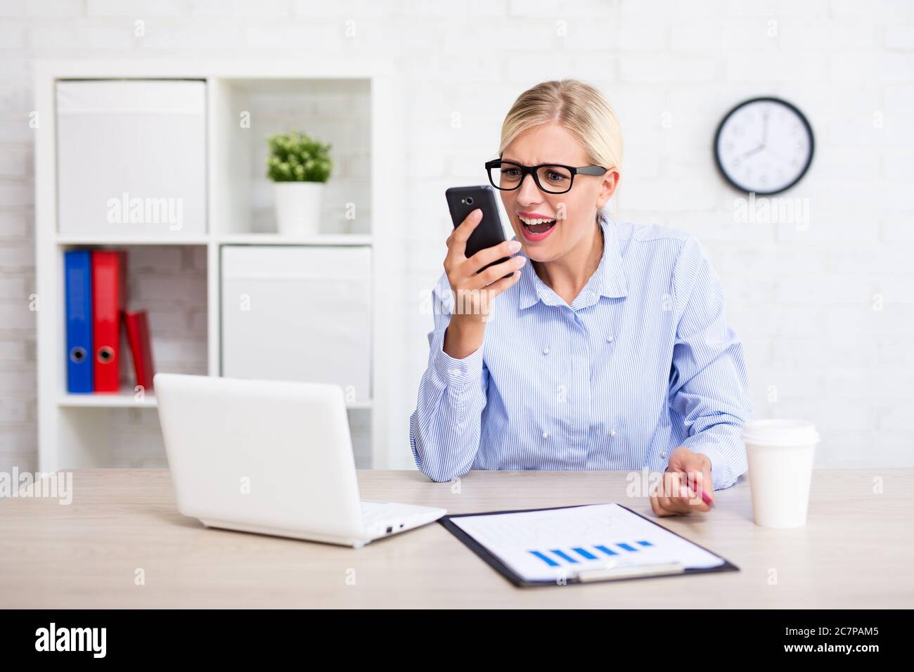 problems at work - angry business woman shouting on phone in office ...