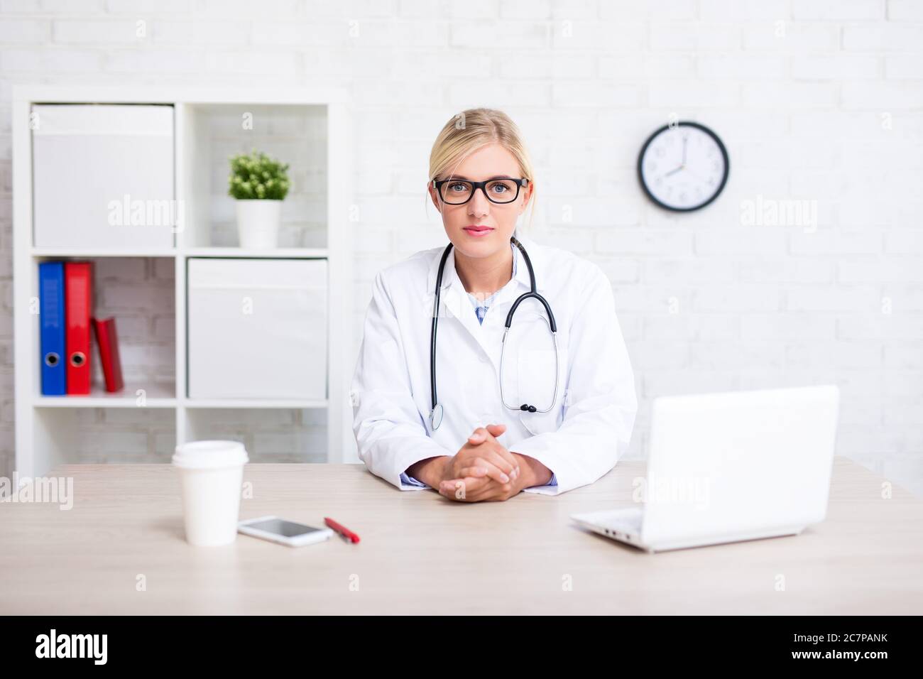 portrait of female doctor sitting in modern office Stock Photo - Alamy