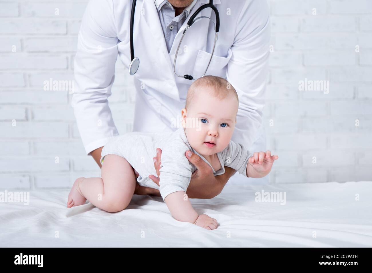 pediatry concept - close up of little baby patient with doctor ...