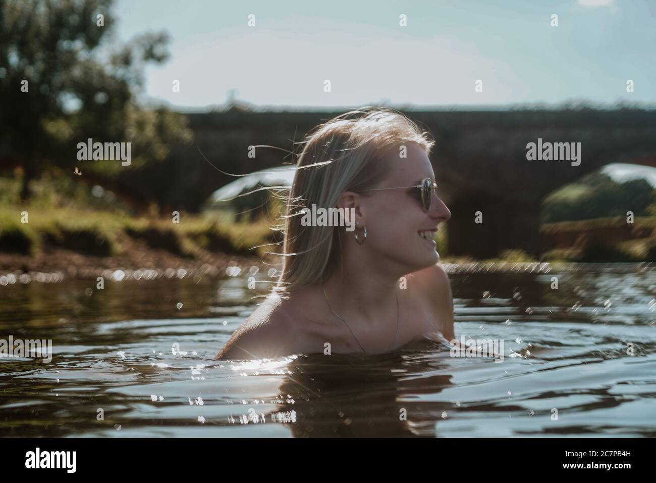 Beautiful woman skinny dipping and wild swimming in river Stock Photo ...