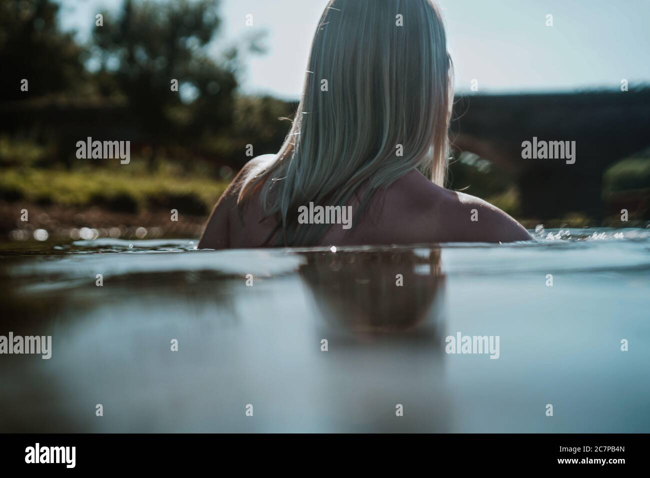 Beautiful woman skinny dipping and wild swimming in river Stock Photo ...